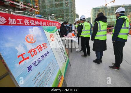 QINGZHOU, CHINA - FEBRUARY 1, 2023 - Workers receive work-related ...