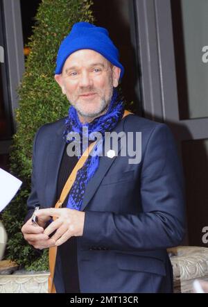 Wearing a blue cap, R.E.M. frontman Michael Stipe grins and waves to ...