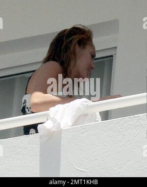 Miley Cyrus and her pal Cheyne, relax on the singer's balcony at her ...