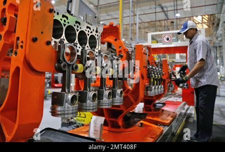 A Ford employee assembles a two liter diesel engine, called panther ...
