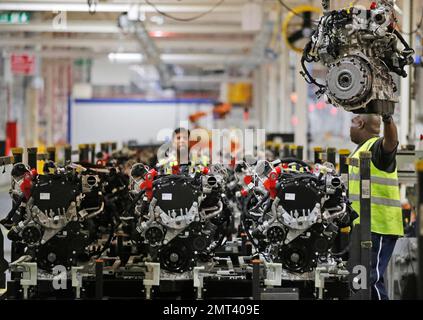 A Ford employee lifts two liter diesel engines, called panther engine ...