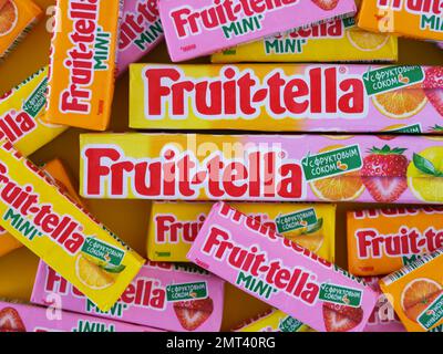 Tambov, Russian Federation - January 22, 2023 A woman holding a pile of different flovoured ...