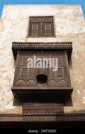 Traditional Arabic mashrabiya window on a tiled wall enclosed with ...