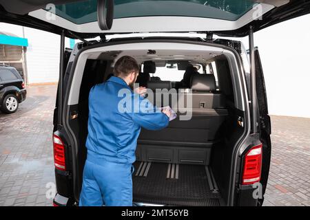 Worker wiping automobile trunk with rag at car wash, closeup Stock ...
