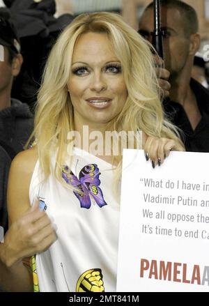 Pamela Anderson wears a colorful spring-like dress on a very dreary day ...