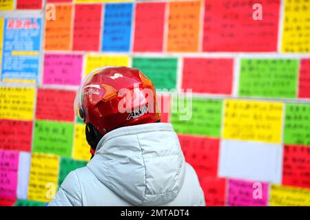 QINGDAO, CHINA - FEBRUARY 1, 2023 - Workers check job postings at a ...