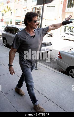 Actor Sylvester Stallone wears a brace around his wrist and thumb to ...
