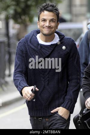 Wearing a classic cable-knit sweater and jeans, Peter Andre is all ...