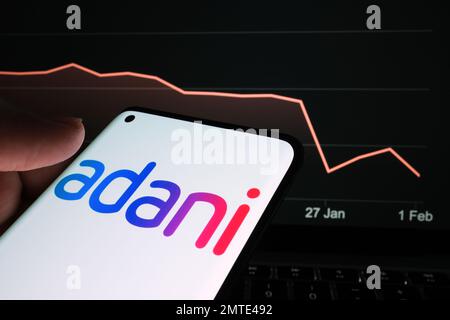 Adani Group logo seen on the smartphone screen and company stock price ...