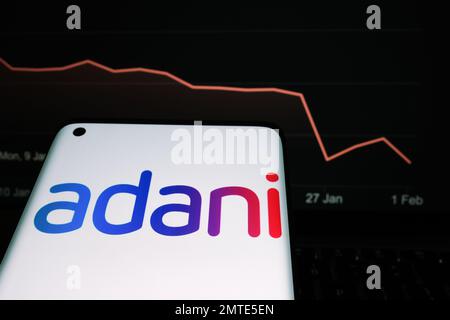Adani Group logo seen on the smartphone screen and company stock price ...