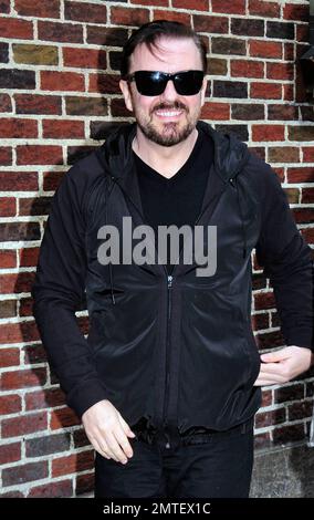 Actor and comedian Ricky Gervais is all smiles as he poses for photos ...