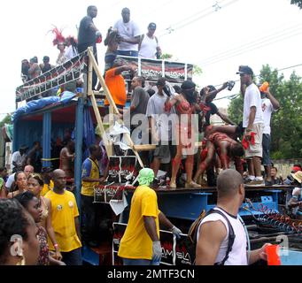Rihanna appears in a parade in the rain as she celebrates Kadooment Day ...