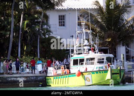 Rosie O'Donnell watches with a large crowd of people as Miami Dade Fire ...