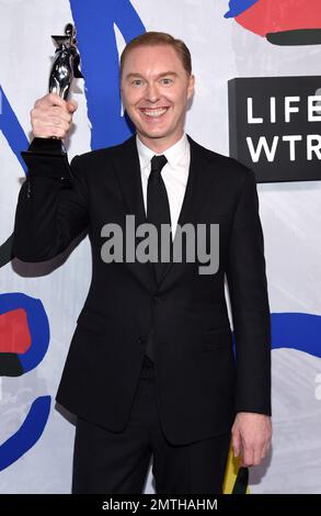 Stuart Vevers poses in the press room with the accessory designer of ...