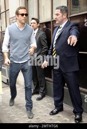 "Green Lantern" star Ryan Reynolds wears a sweater vest and jeans as he ...