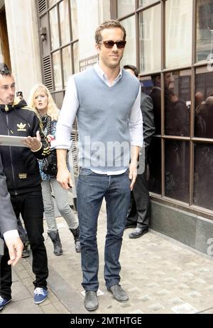 "Green Lantern" star Ryan Reynolds wears a sweater vest and jeans as he ...