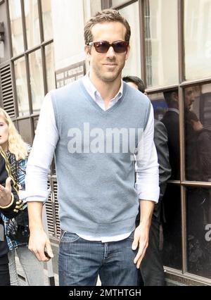 "Green Lantern" star Ryan Reynolds wears a sweater vest and jeans as he ...
