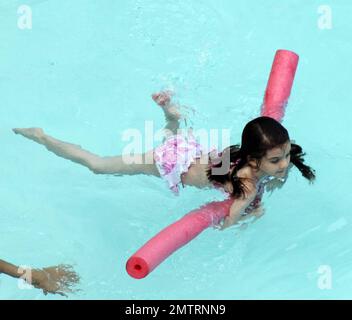 Suri Cruise shows off her improving swimming skills in the pool. Suri ...