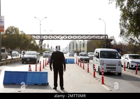 Islamabad. 1st Feb, 2023. A policeman stops a vehicle at a police check ...
