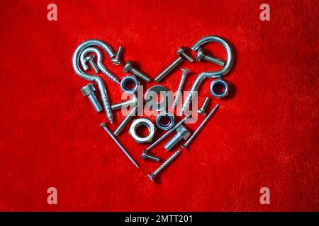 Bolts, nuts,hex and other construction tools laid out in a heart shape ...