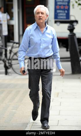Singer Tony Christie is all smiles as he poses for photos while ...