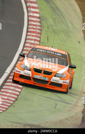 Stephen Jelley on Brands Hatch driving the orange Team RAC BMW during ...