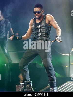 With sweat pouring from his face and clad in a buckle-detailed vest ...