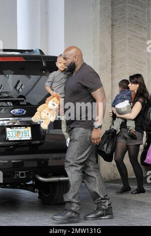 Rapper Usher and his children with the help of bodyguards and staff ...