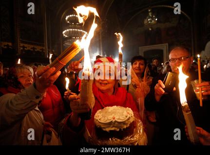 Ukrainian Orthodox faithful light candles from the Holy Fire brought ...