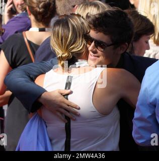 Actor Zac Efron hugs a female friend before he heads down the red ...
