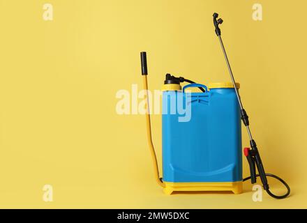 Manual insecticide sprayer on yellow background. Pest control Stock ...