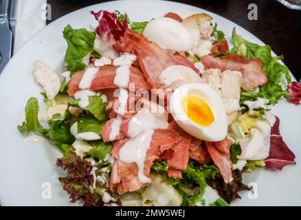 Fresh Caesar salad with crispy bacon mango chunks cream dressing and ...
