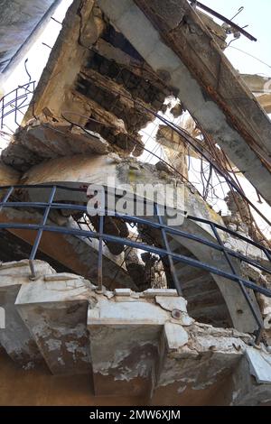 A low angle vertical shot of a ruined building with blue sky in the ...