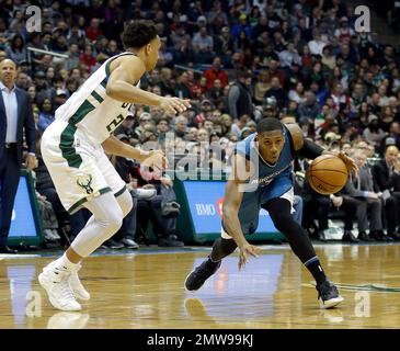 Minnesota Timberwolves' Kris Dunn, right, drives as Nemanja Bjelica ...