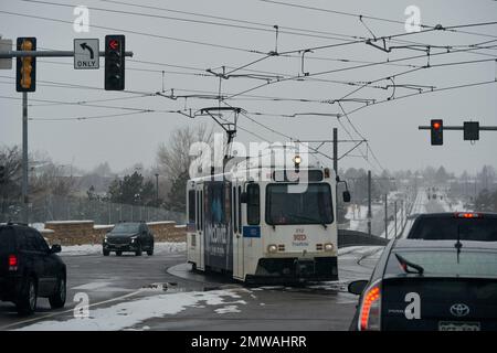 RTD light rail train and car moves along California Street in downtown ...