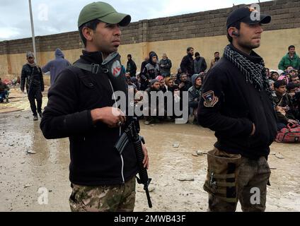 Displaced men who fled their homes due to fighting between Iraqi ...