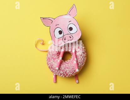 Funny pig made with donut and piece of paper on pink background, top ...