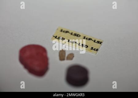Close up on psychedelic set exstacy pills lsd papers and mdma small rocks doping background high ...
