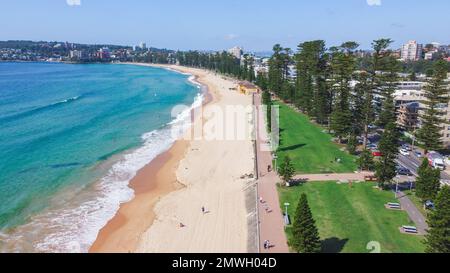 An aerial shot of Manly Beach with resort buildings around the sea ...