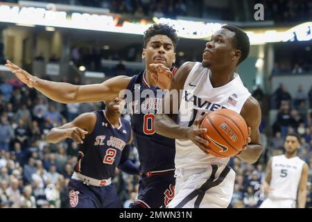 Xavier's Malcolm Bernard (11) drives around DePaul's Billy Garrett Jr ...