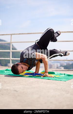 Capoeira culture. Low angle shot of a young male breakdancer in an ...