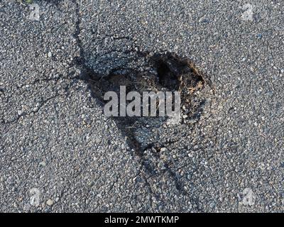 hole in tarmac in poorly mantained uneven bumpy road Stock Photo - Alamy