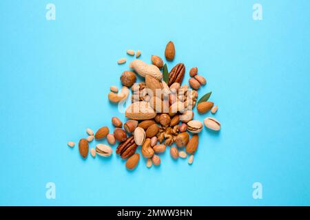 Different delicious nuts on light blue background, flat lay Stock Photo ...