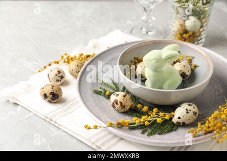 Beautiful table setting with mimosa flowers and candles in room Stock ...