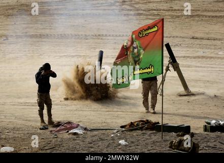 Iraqi Army soldiers fire a mortar round during a training mission in ...