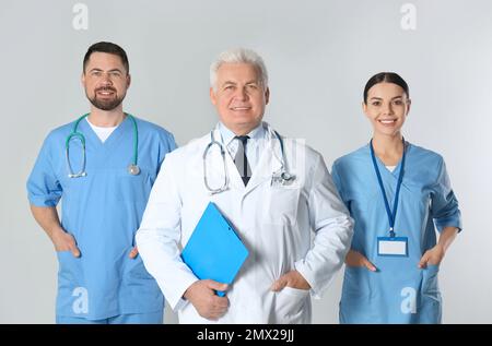 Group of doctors against light background. Medical service Stock Photo ...