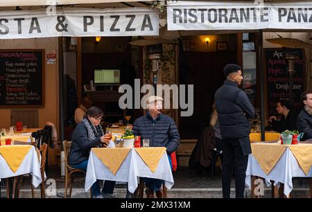 adult couple sitting making an aperitif in a typical traditional Roman ...
