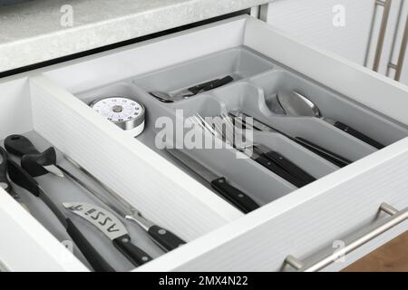Open drawer with different utensils. Order in kitchen Stock Photo - Alamy