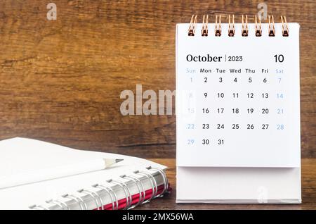 October 2023 Monthly desk calendar for 2023 year with wooden pencil on ...