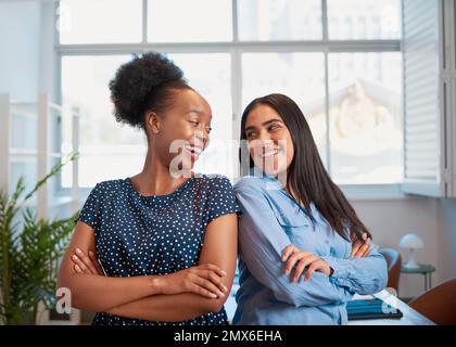 Two business women stand back to back, successful co-founders office ...